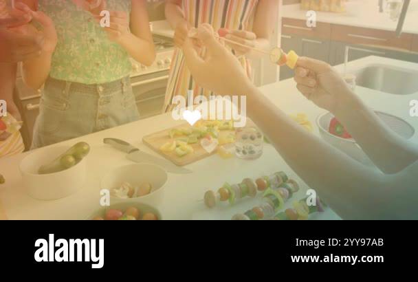 Preparing vegetable skewers, people in kitchen with heart animation ...