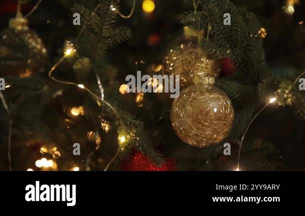 A closeup of a decorated Christmas tree with colorful ornaments and ...