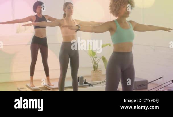 Exercising in fitness studio, women stretching arms, glowing circles ...