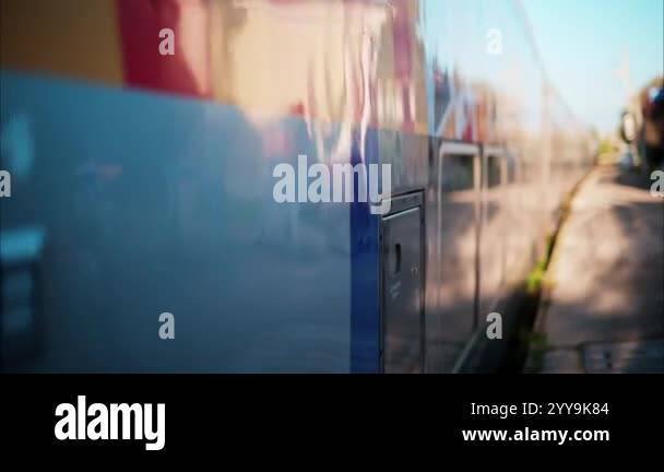 Close up of a blue train stopping at the station in France, with people ...