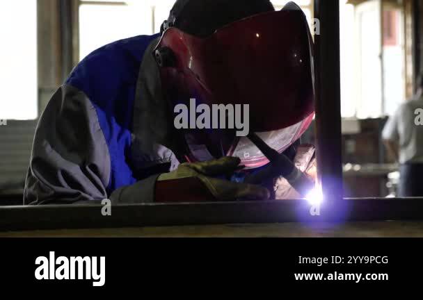 Close-up of a welder welding parts with a semi-automatic welding ...