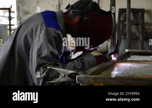 Close-up of a welder welding parts with a semi-automatic welding ...