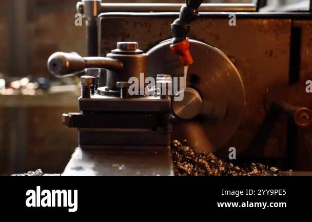 Close-up of a lathe cutting brass shaft parts and shavings ...