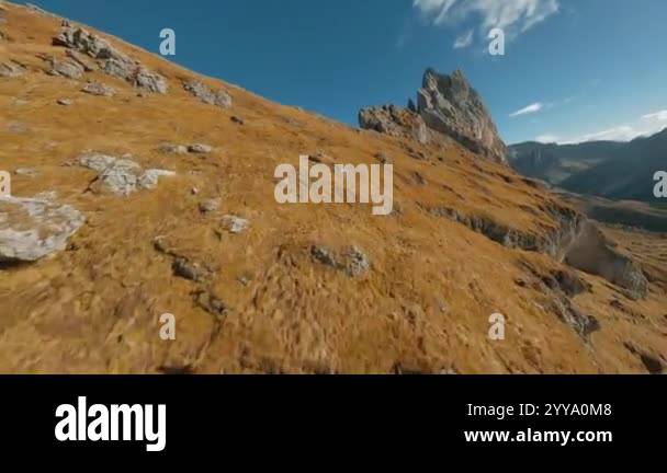 FPV drone flying close to the sharp mountain cliffs of Seceda, Italy ...