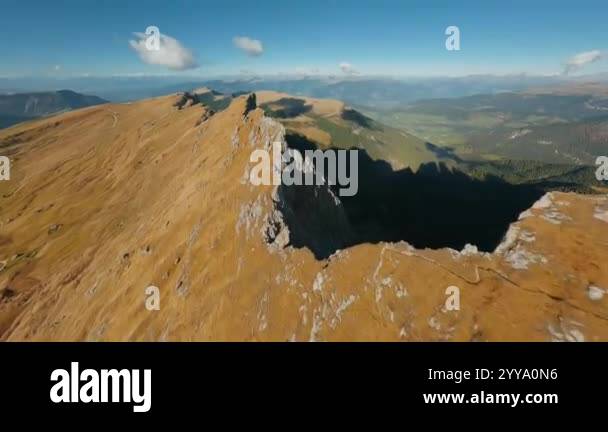 FPV drone flying close to the sharp mountain cliffs of Seceda, Italy ...