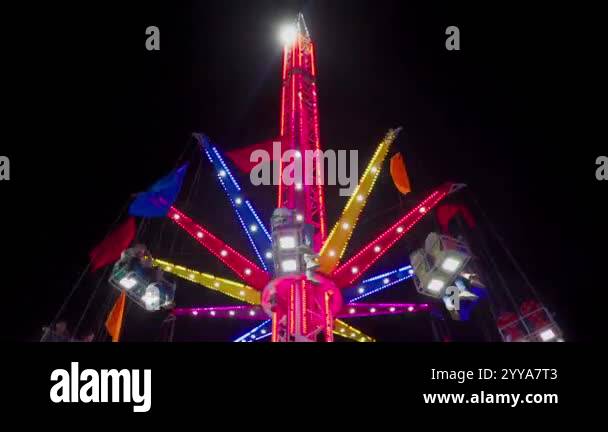 Flying chairs attraction in ascending motion, captured as it reaches ...