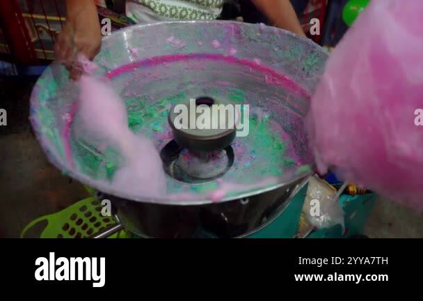 Making cotton candy at a fair, showing step by step how the sugar is ...