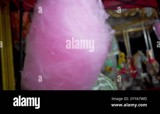 Close-up of a freshly made cotton candy, with a soft and fluffy texture ...