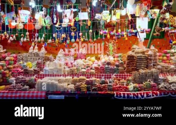 Colorful stall selling typical local sweets, with a variety of ...