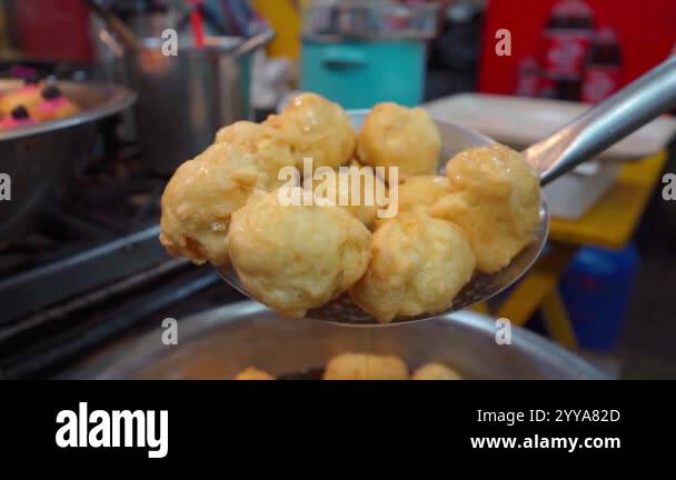 Close-up of freshly fried fritters, highlighting their golden and ...
