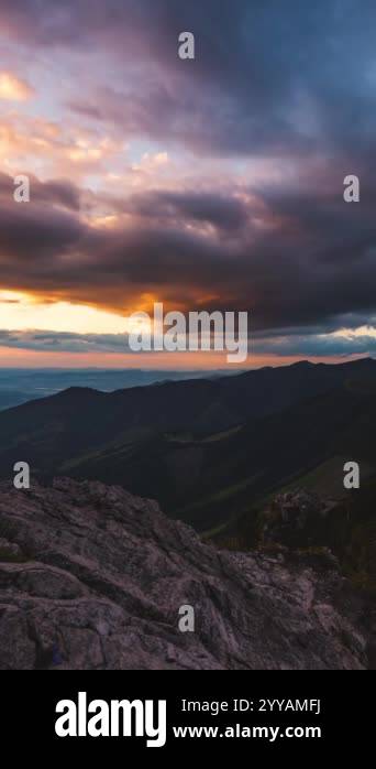 Vertical Panoramic view of fast dramatic clouds moving over rocky alps ...