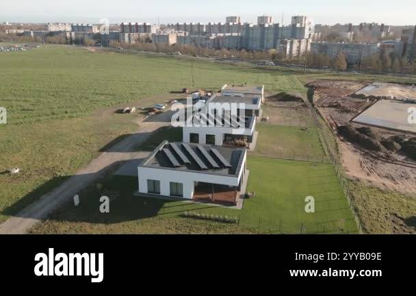 Siauliai, Lithuania, 2024: aerial top down view workers on rooftop lay ...