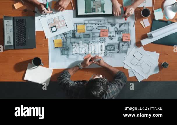 Top down view of civil engineer handed document while looking at ...