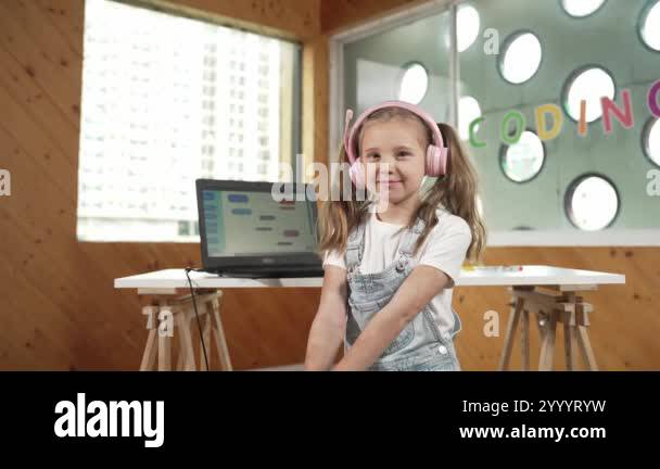 Cute caucasian girl smile at camera while laptop show coding screen ...