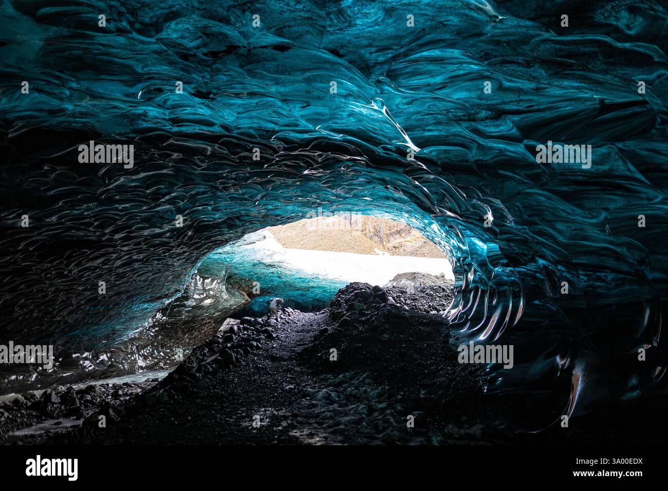 The view within an ice cave showcases striking blue patterns in the ice ...