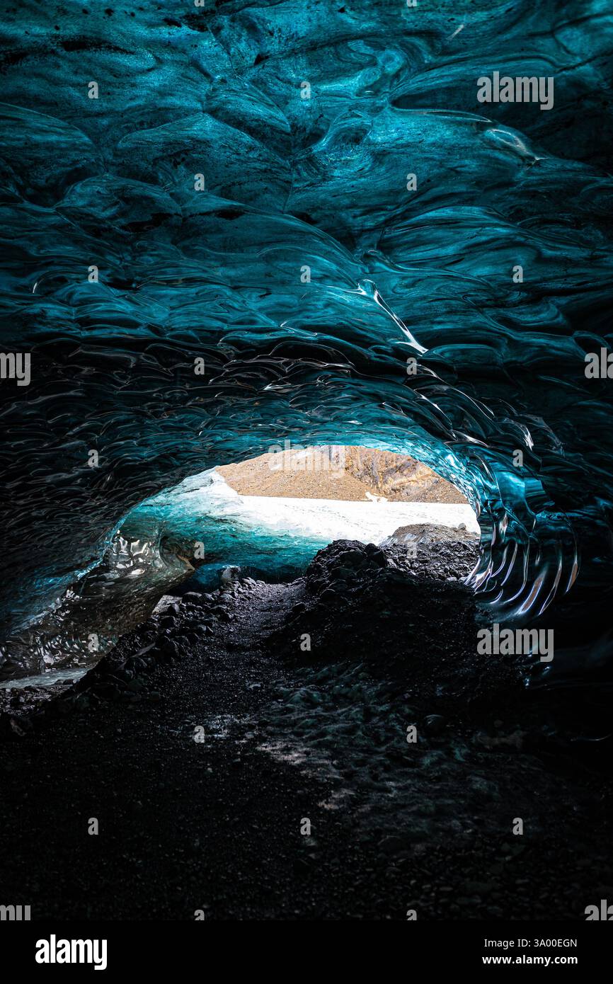 Entering an ice cave showcases stunning blue ice formations overhead ...