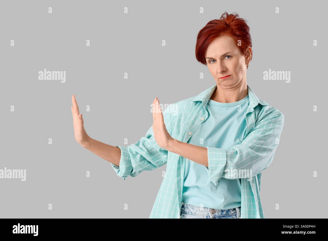 Mature woman rejecting something on light background. Rules concept ...