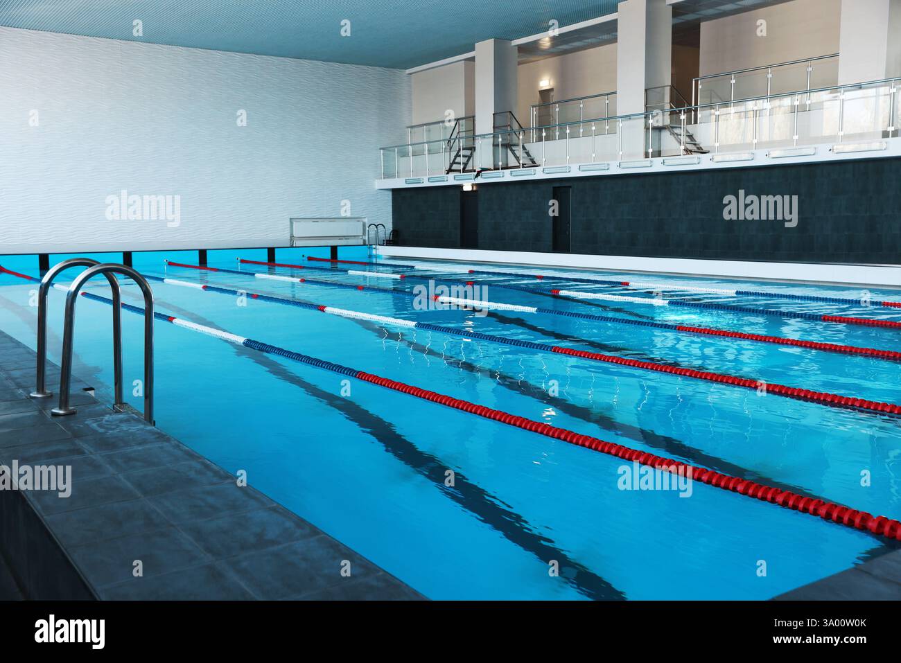 Swimming pool with clean water and lane dividers indoors Stock Photo ...