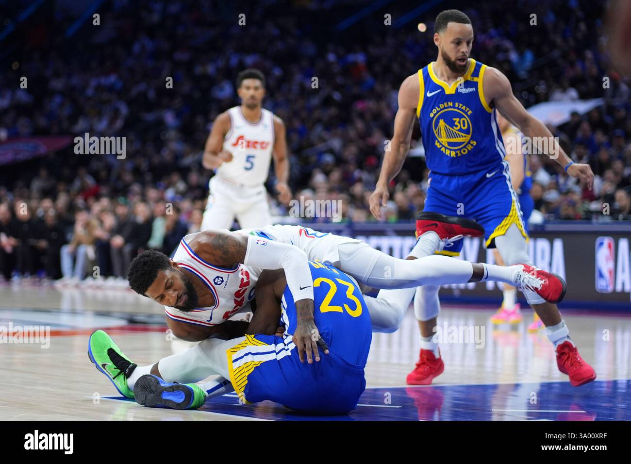 Philadelphia 76ers' Paul George, top, collides with Golden State ...