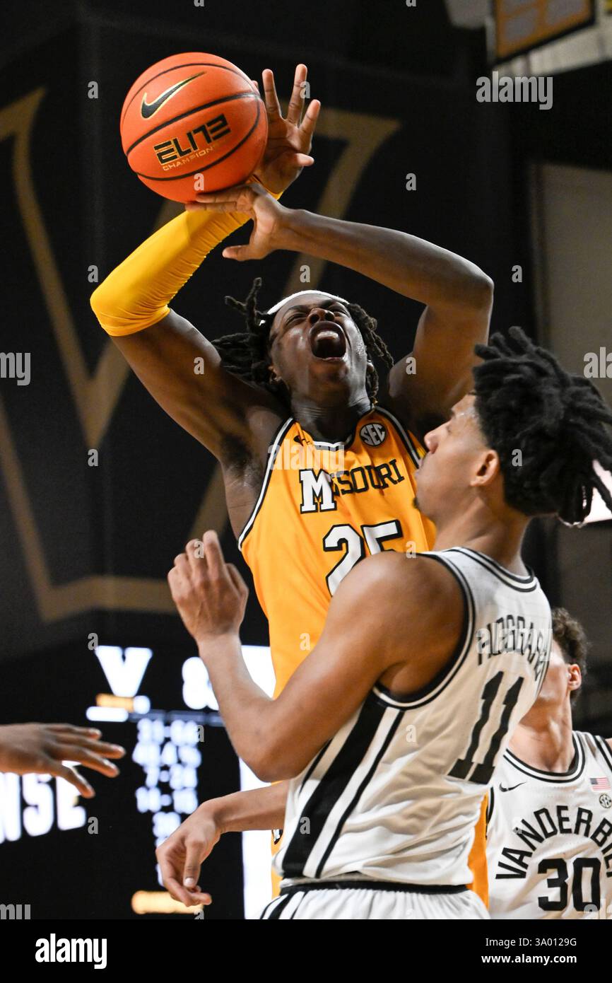 Missouri guard Mark Mitchell is fouled as Vanderbilt guard Chris Manon ...
