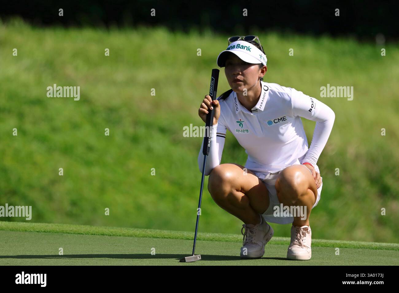 Lydia Ko of New Zealand lines up her putt during the round four of the ...