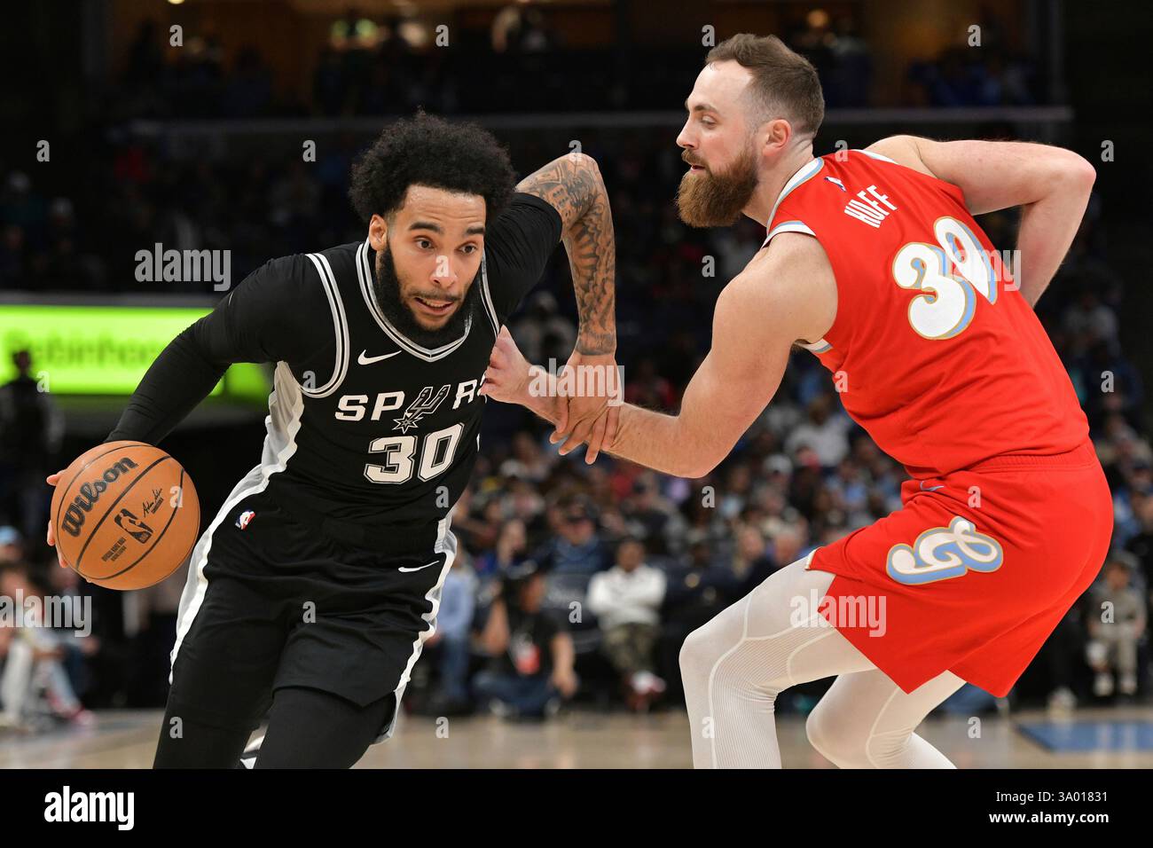 San Antonio Spurs forward Julian Champagnie, left, handles the ball ...
