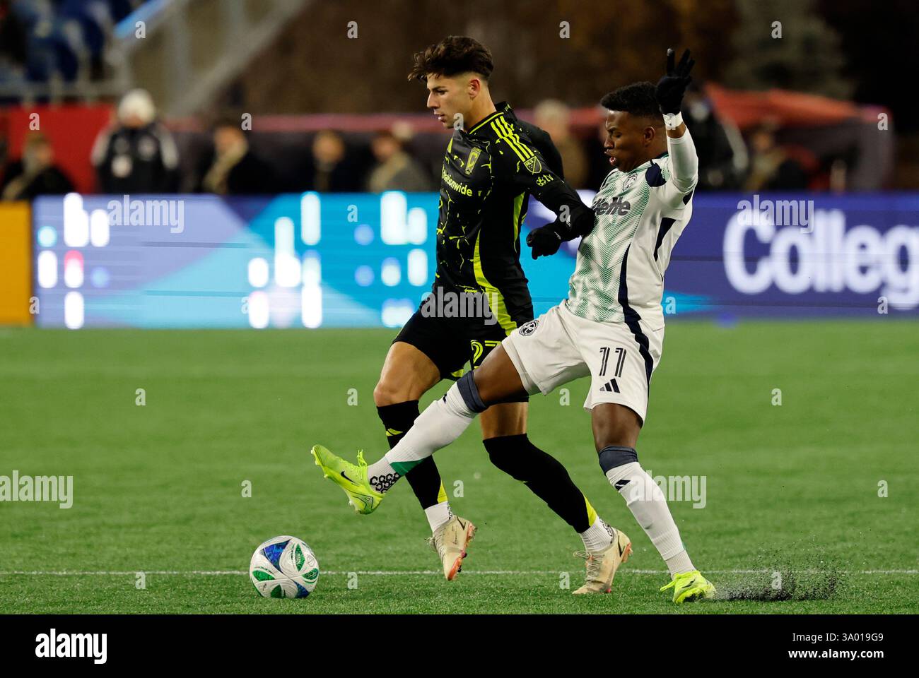 FOXBOROUGH, MA - MARCH 01: Max Arfsten #27 of Columbus Crew holds off ...