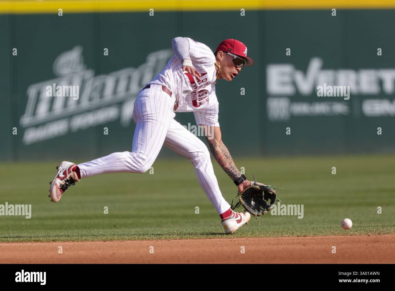 March 1, 2025: Razorback short stop Wehiwa Aloy (9) looks to scoop a ...