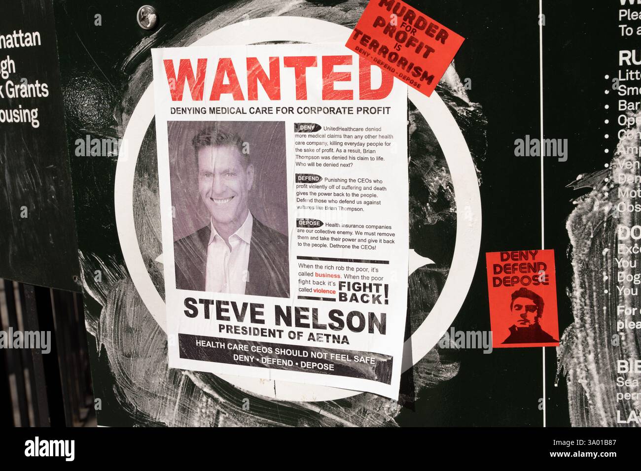 Wanted posters of various health care executives are seen in Lower ...