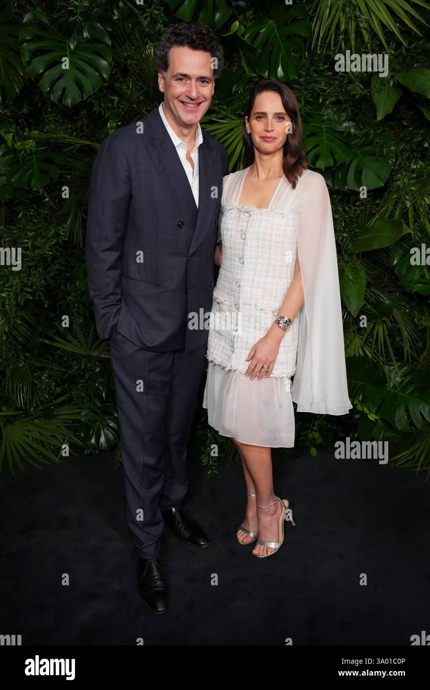 Charles Guard, left, and Felicity Jones arrive at Chanel's 16th Annual ...