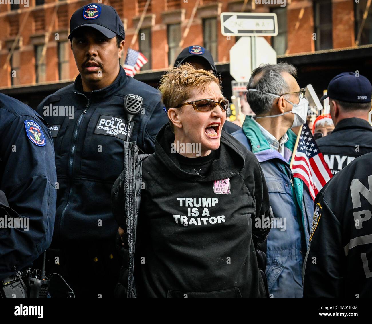 NYPD officers arrest protestors for blocking the entrance to the Tesla ...