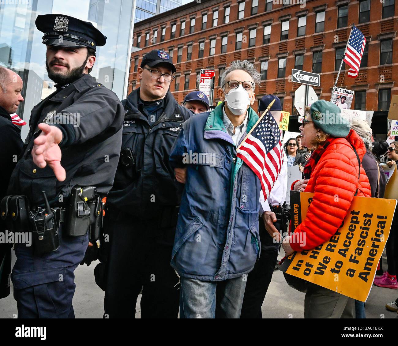 NYPD officers arrest protestors for blocking the entrance to the Tesla ...