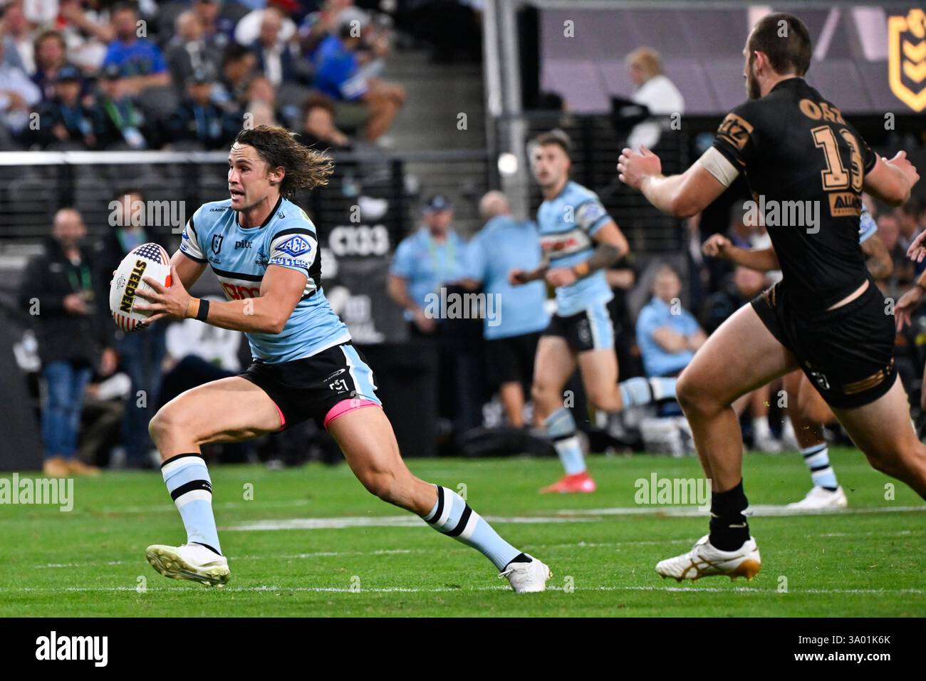 Cronulla Sharks Nicho Hynes runs away from Penrith Panthers Isaah Yeo ...