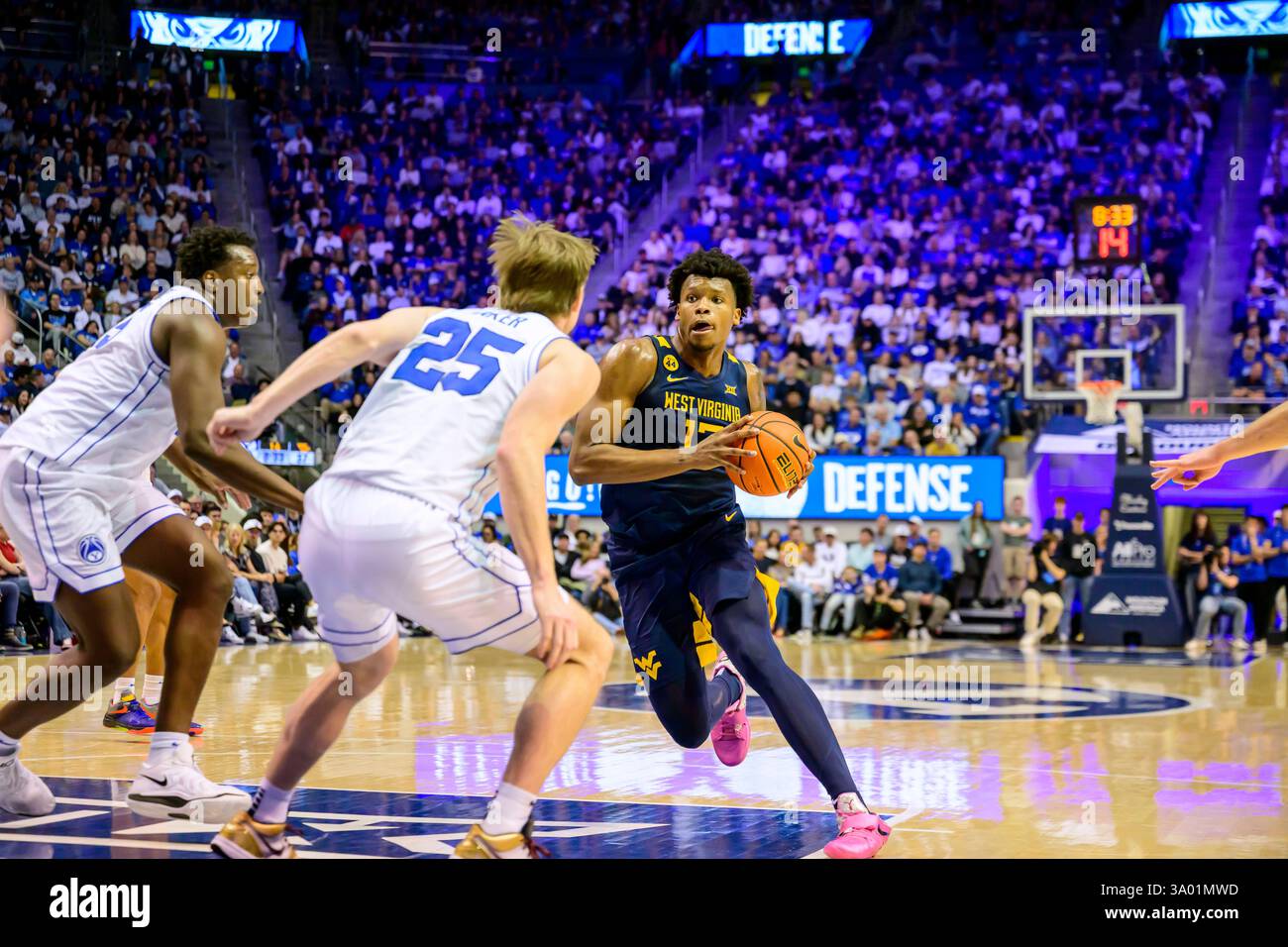 West Virginia forward Amani Hansberry (13) drives to the hoop defended ...