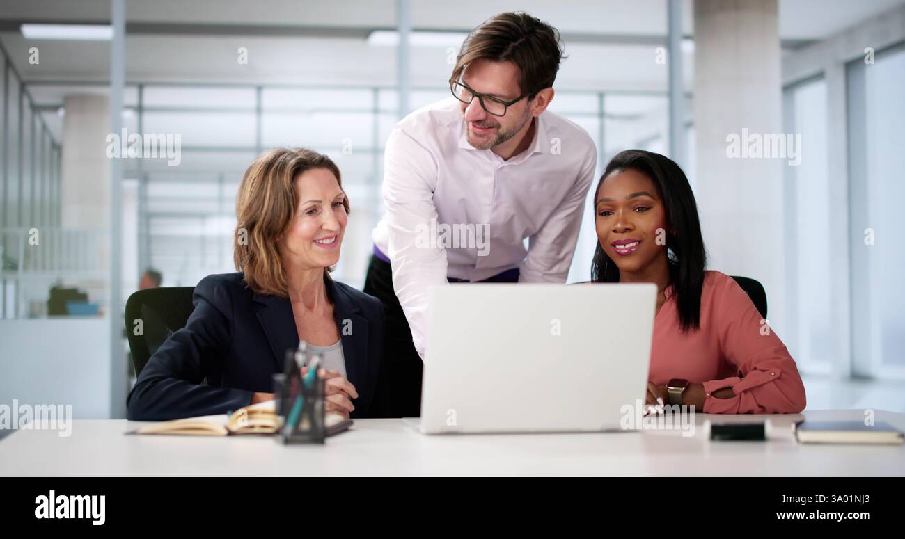 Collaborating Business Team Smiling Together On Laptop In Office ...
