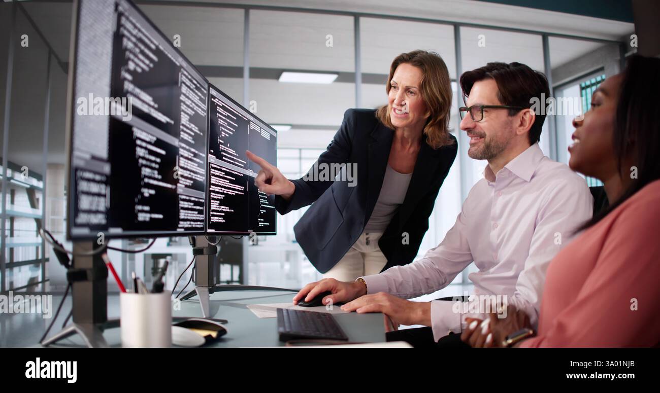 Diverse coding team collaborating on software development at the office ...