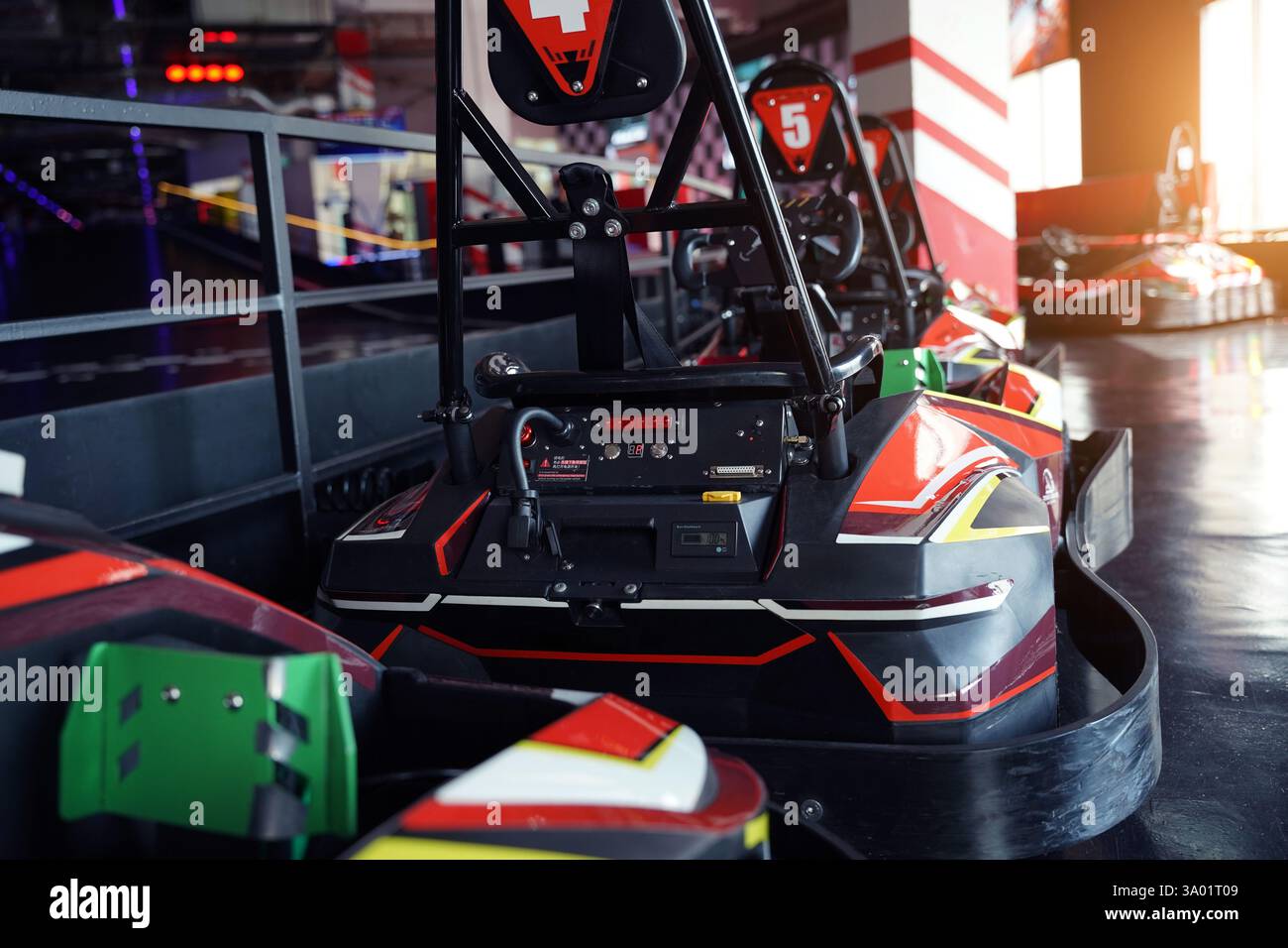 New electric go karts in the modern indoor racing track Stock Photo - Alamy