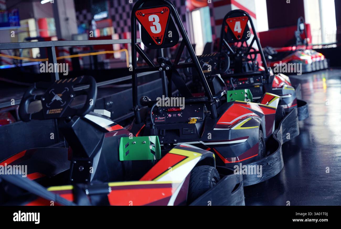 New electric go karts in the modern indoor racing track Stock Photo - Alamy