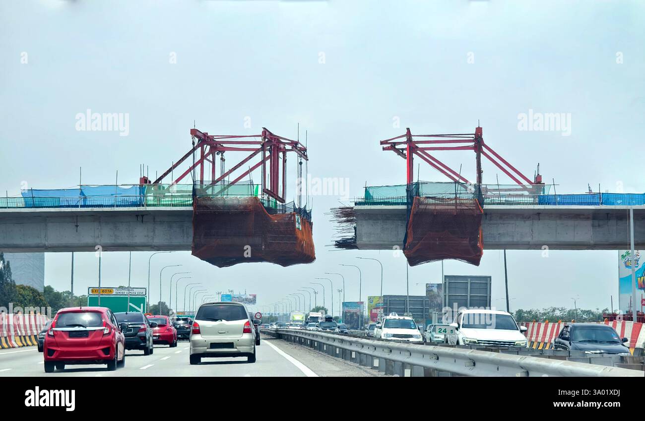 Cars drive on a busy highway with a bridge under construction Stock ...