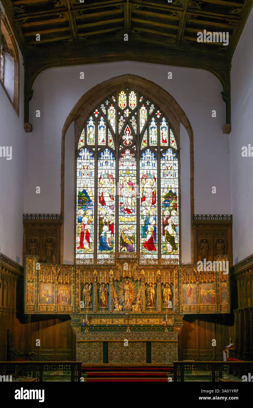 Stained glass east window, elaborately carved gilt altar reredos screen ...