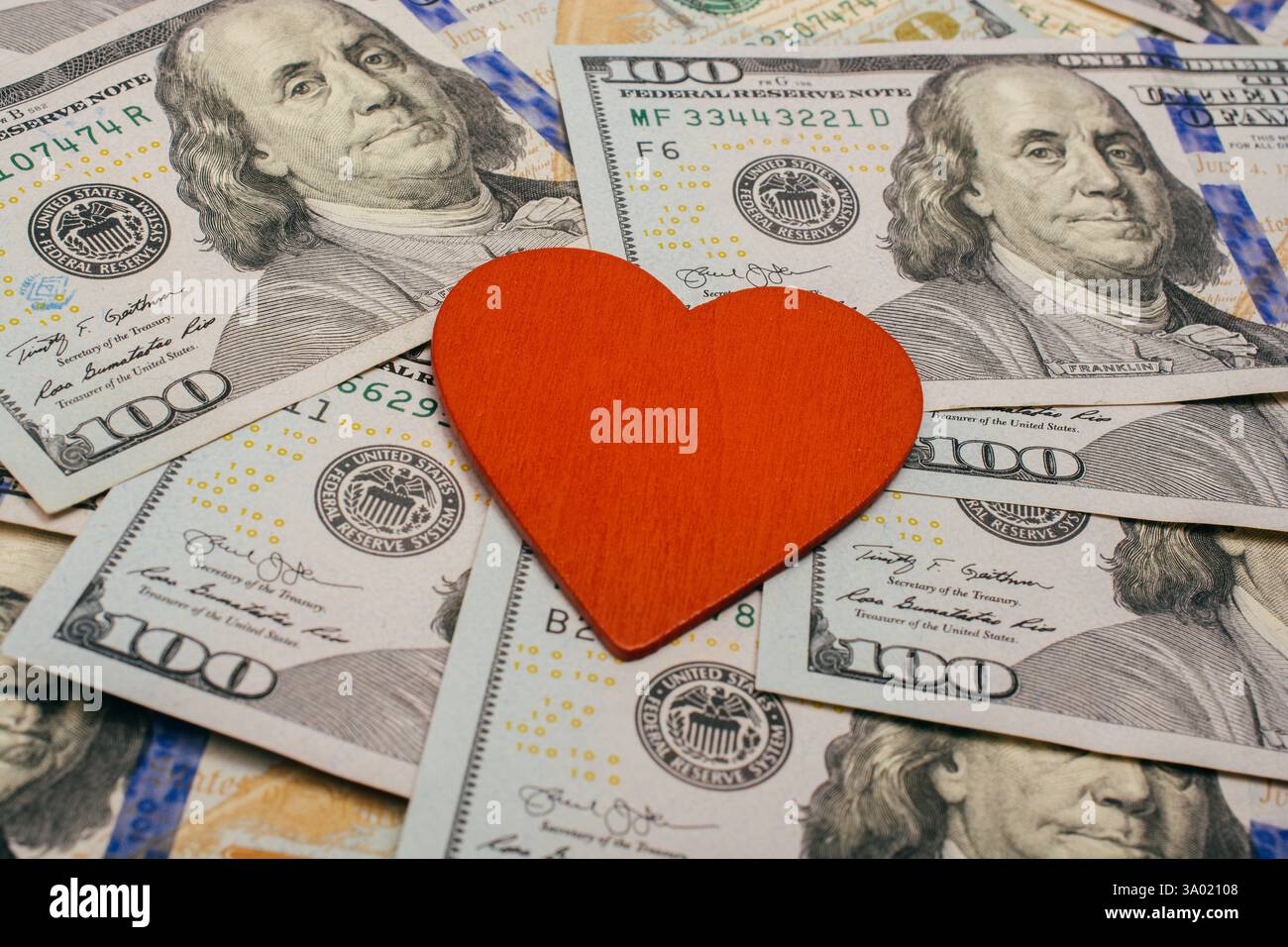 Red heart lies on dollar bills. Concept of selling love for money Stock ...