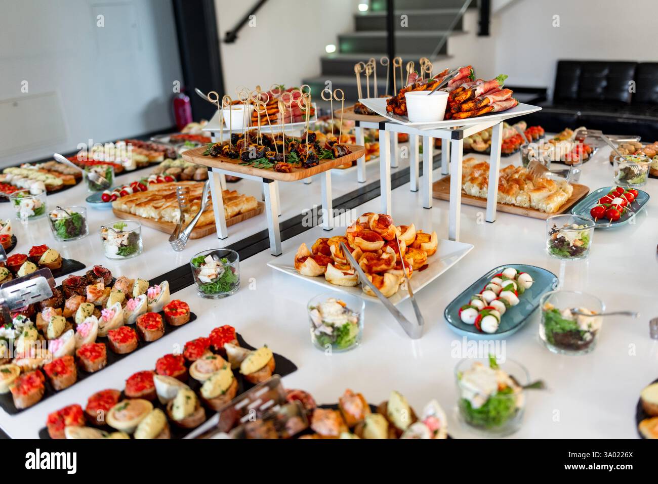 A vibrant assortment of canapes is beautifully arranged on a long table ...