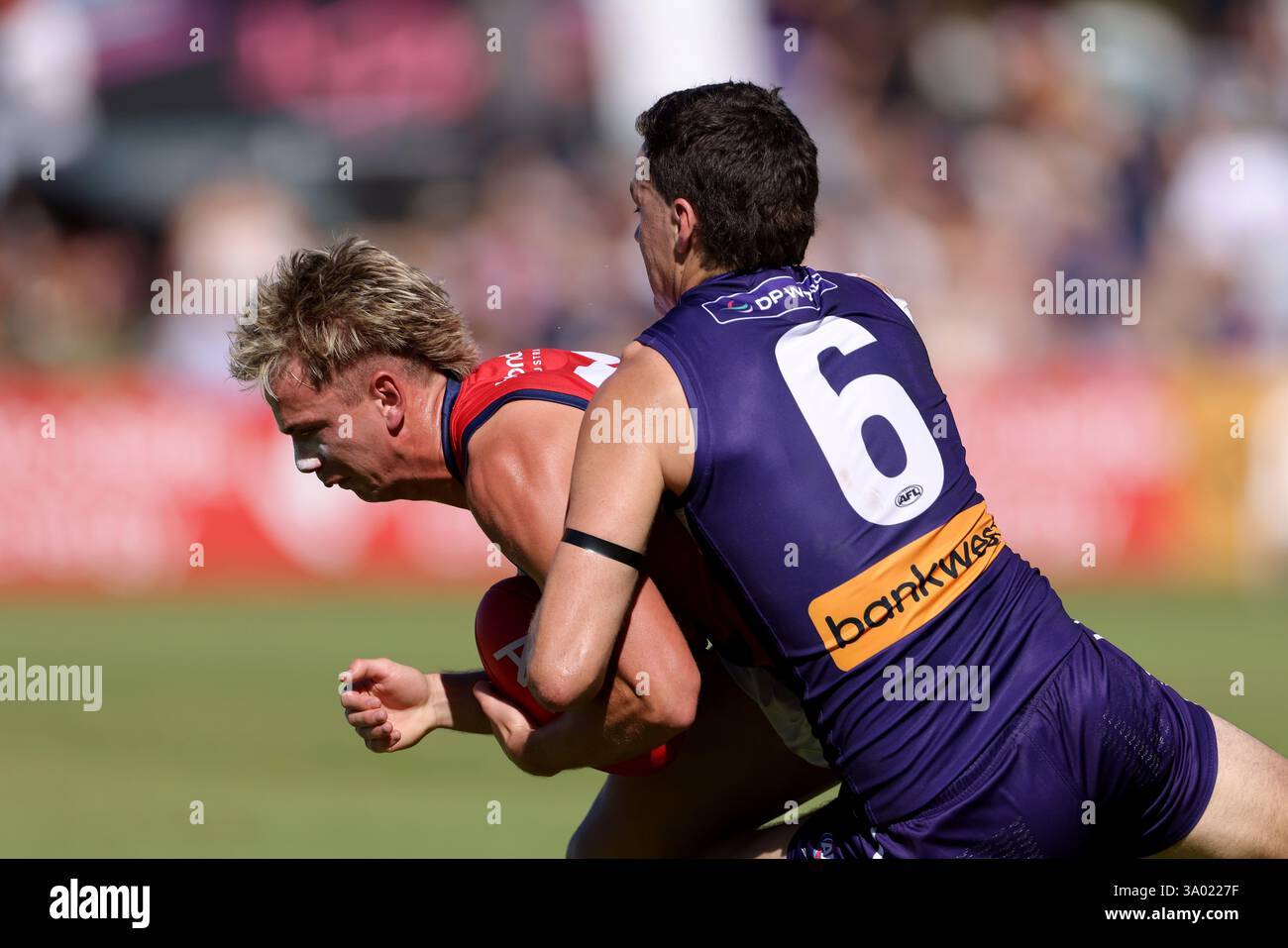 Perth, Australia. 02nd Mar, 2025. Harry Sharp of the Demons is tackled ...