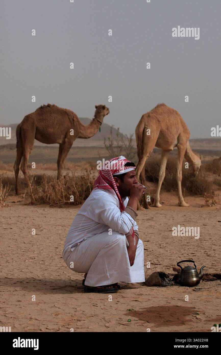 A Bedouin man wearing the traditional red-and-white keffiyeh which is a ...