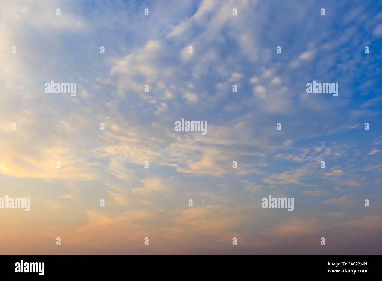 The morning sky with soft scattered clouds. The sky has a gradient from ...