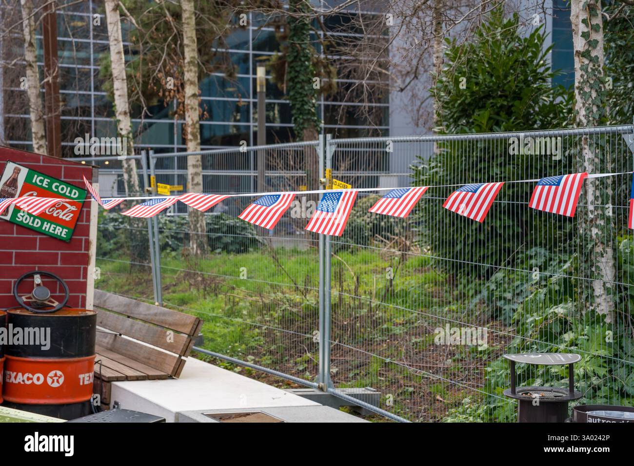 Colorful American flags dance in the breeze near a bustling outdoor ...
