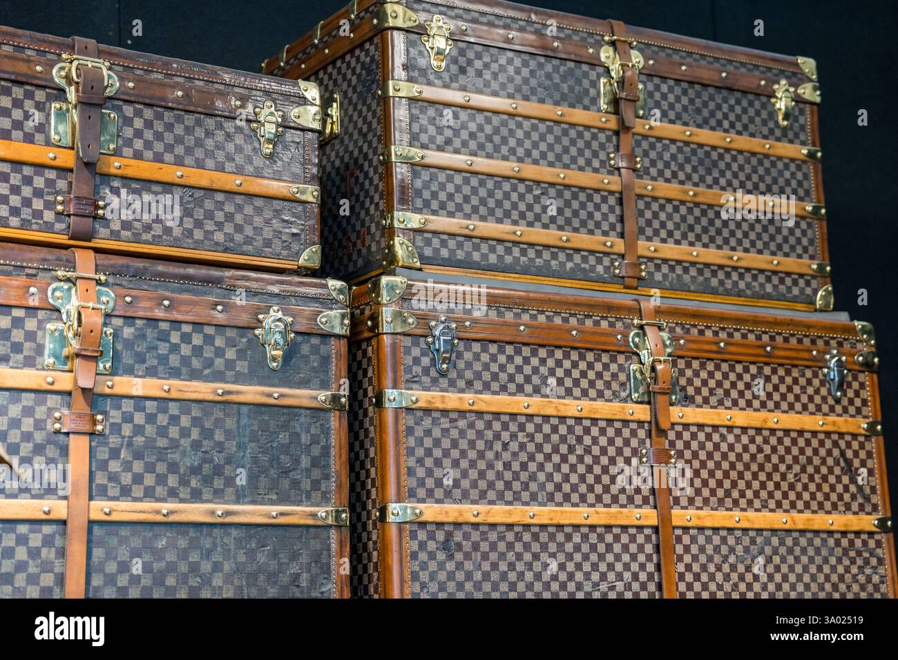 Vintage trunks stacked high exude charm and history in a rustic setting ...