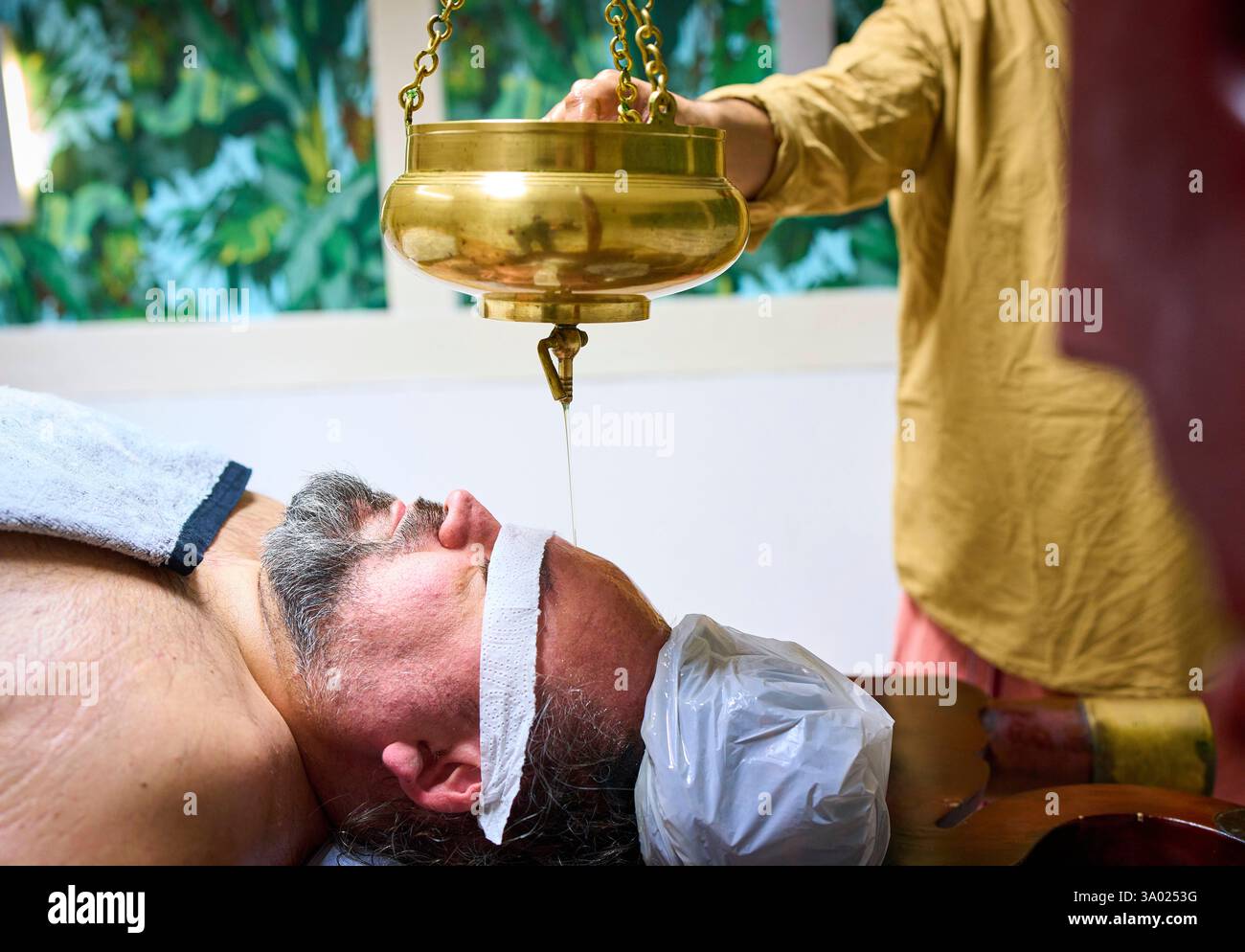 An adult receiving traditional ayurvedic Shirodhara, the Ayurvedic ...