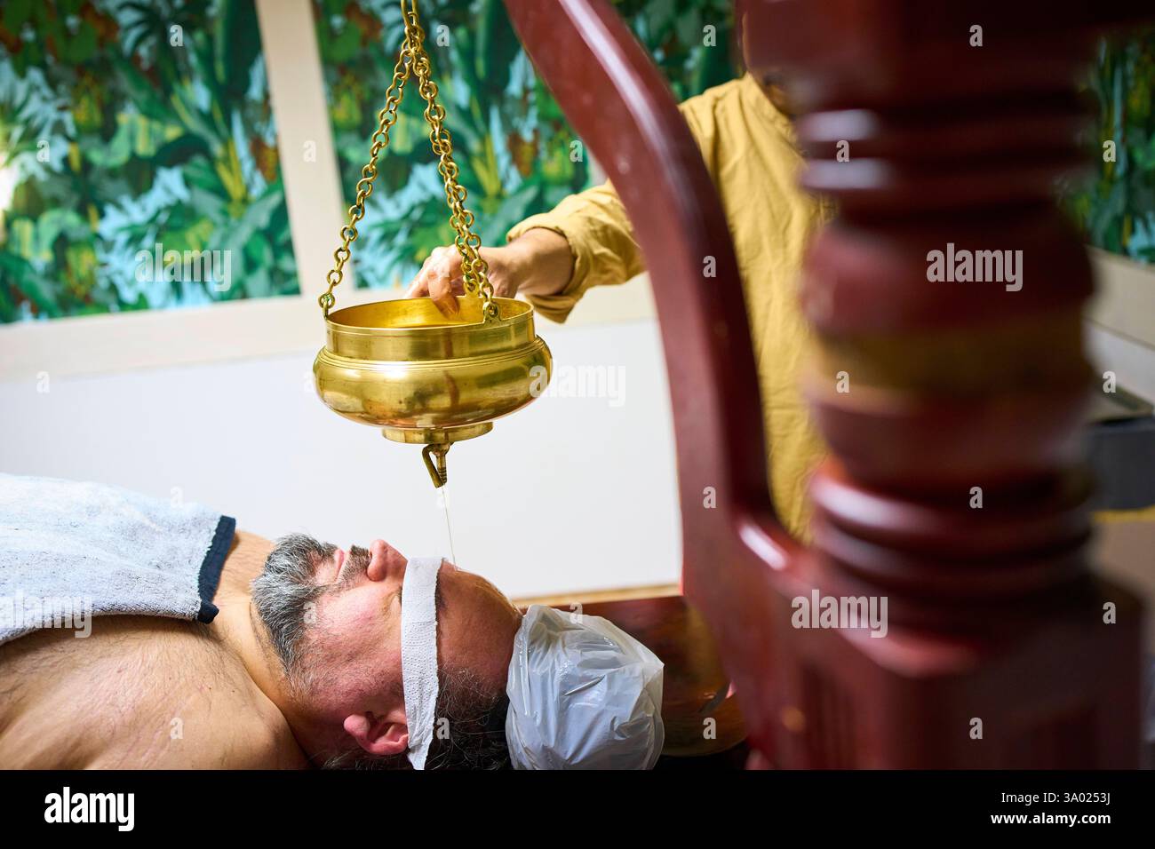 An adult receiving traditional ayurvedic Shirodhara, the Ayurvedic ...