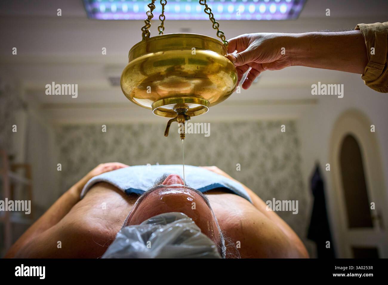 An adult receiving traditional ayurvedic Shirodhara, the Ayurvedic ...